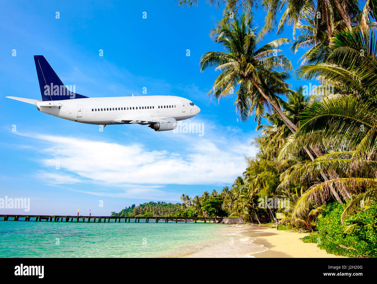 Jet plane over the tropical sea Stock Photo - Alamy