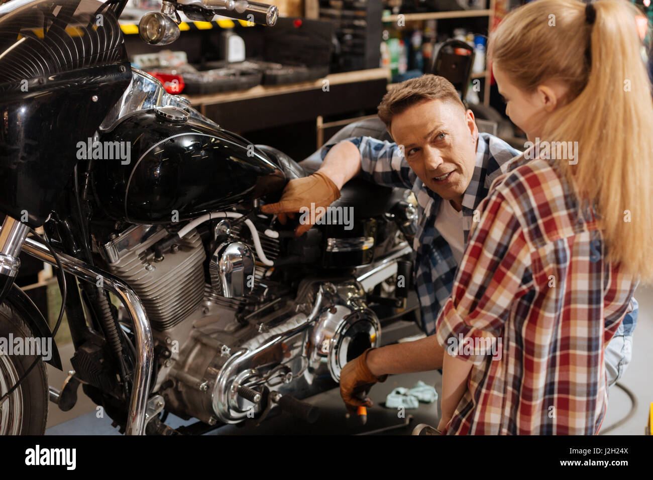Dedicated skillful mechanic telling some interesting facts Stock Photo ...