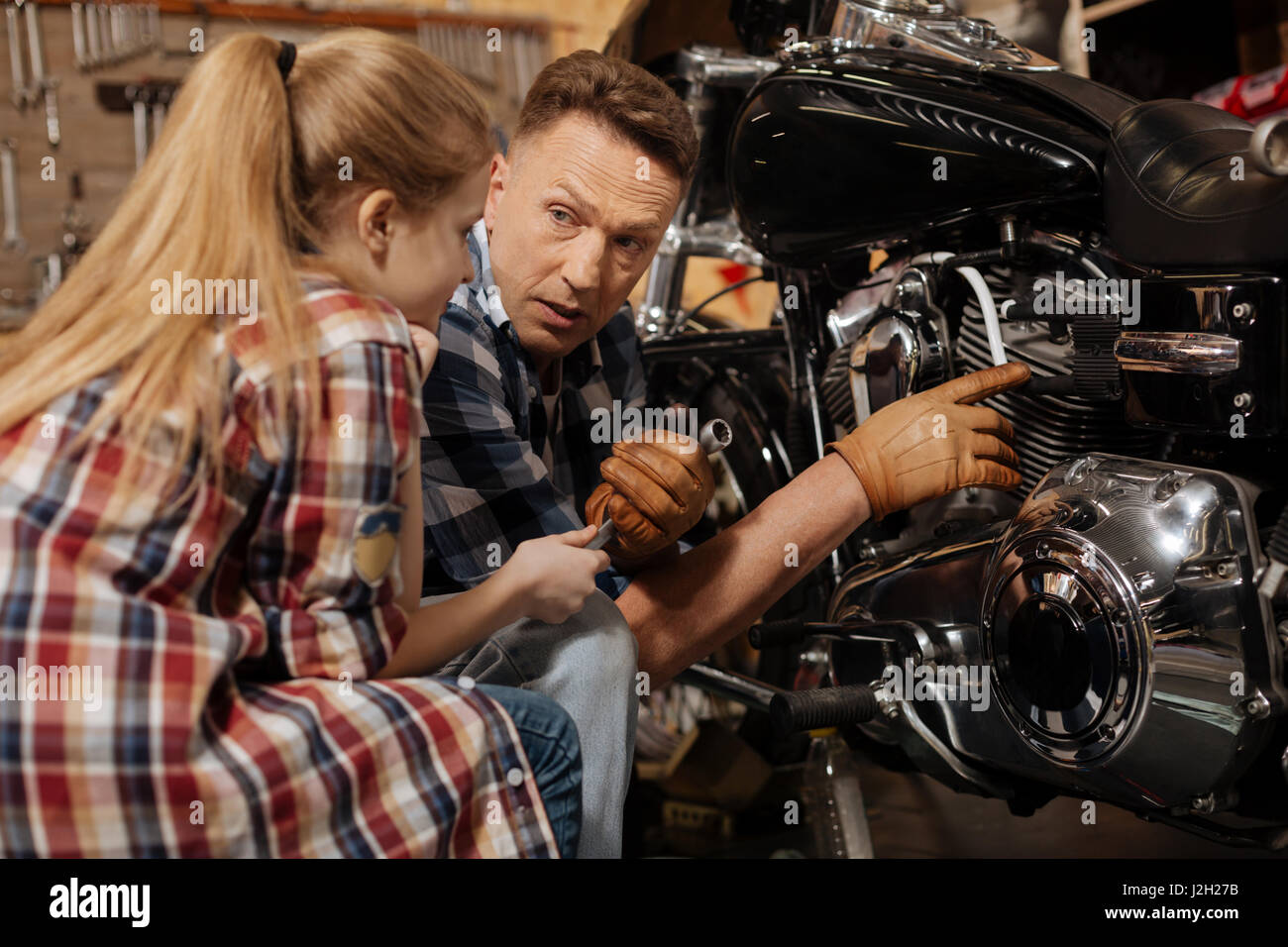 Hardworking intelligent tinker explaining how things work Stock Photo ...