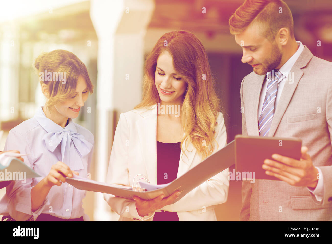 business team with tablet pc and folders at office Stock Photo - Alamy