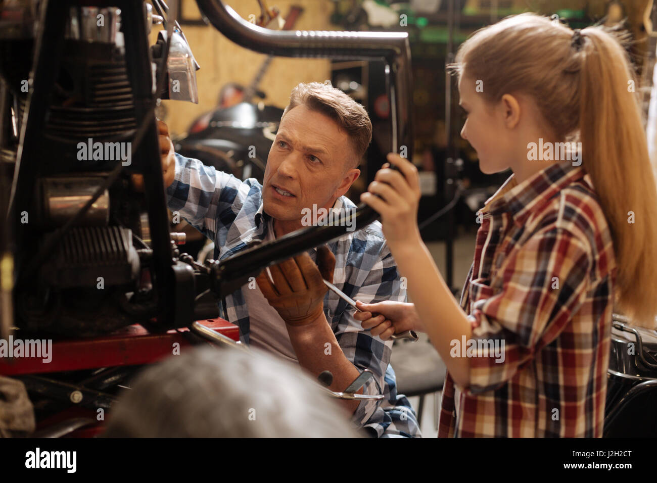 Trained skillful mechanic needing a special tool Stock Photo - Alamy