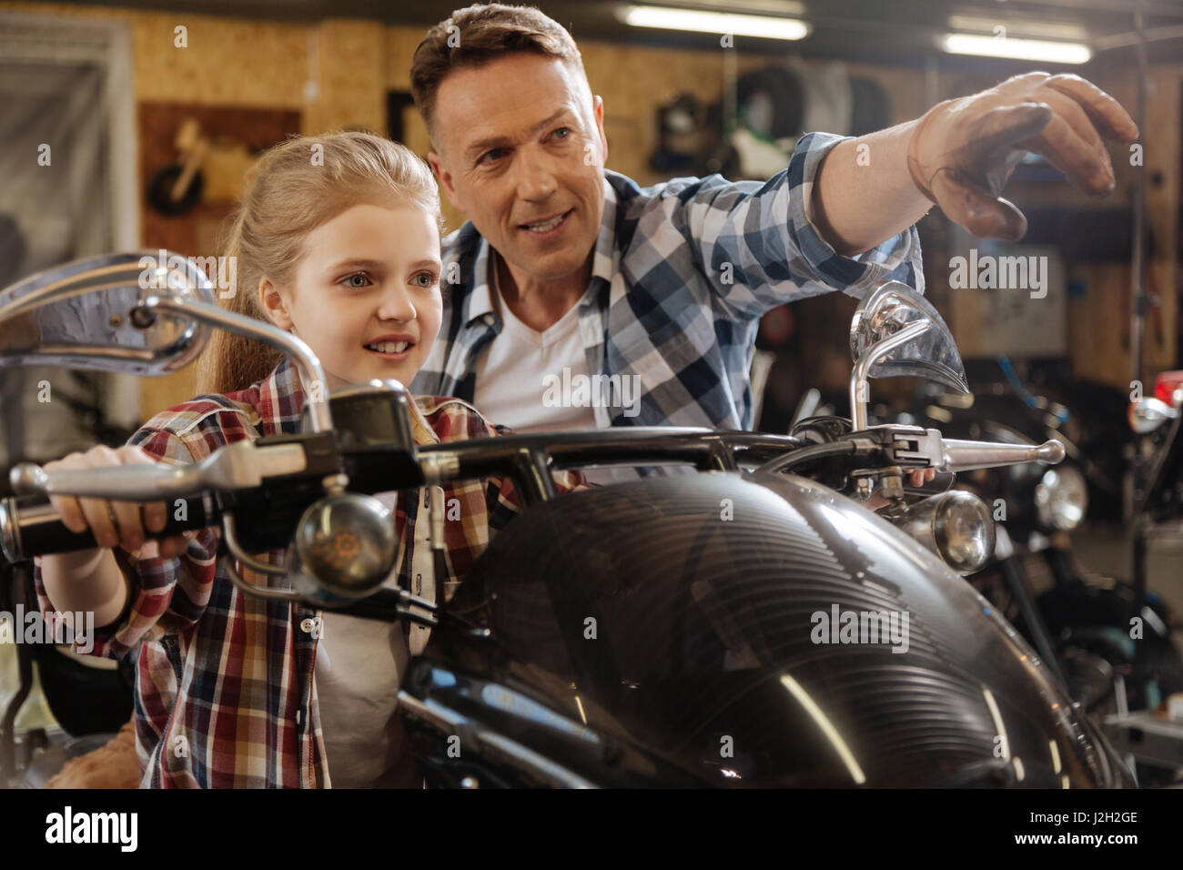 Ambitious biker family imagining things together Stock Photo - Alamy