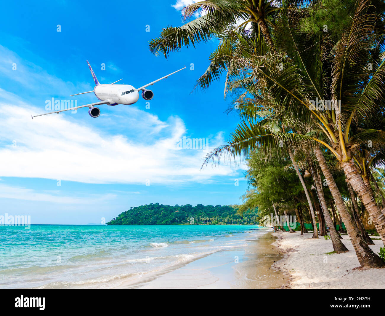 Plane fly over ocean Stock Photo - Alamy