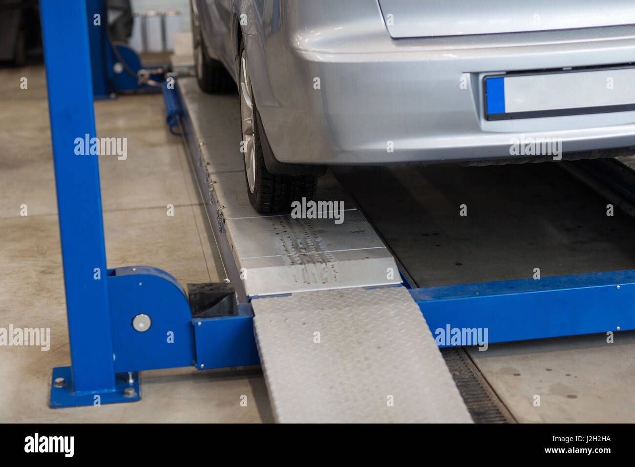 car on lift at repair station Stock Photo - Alamy