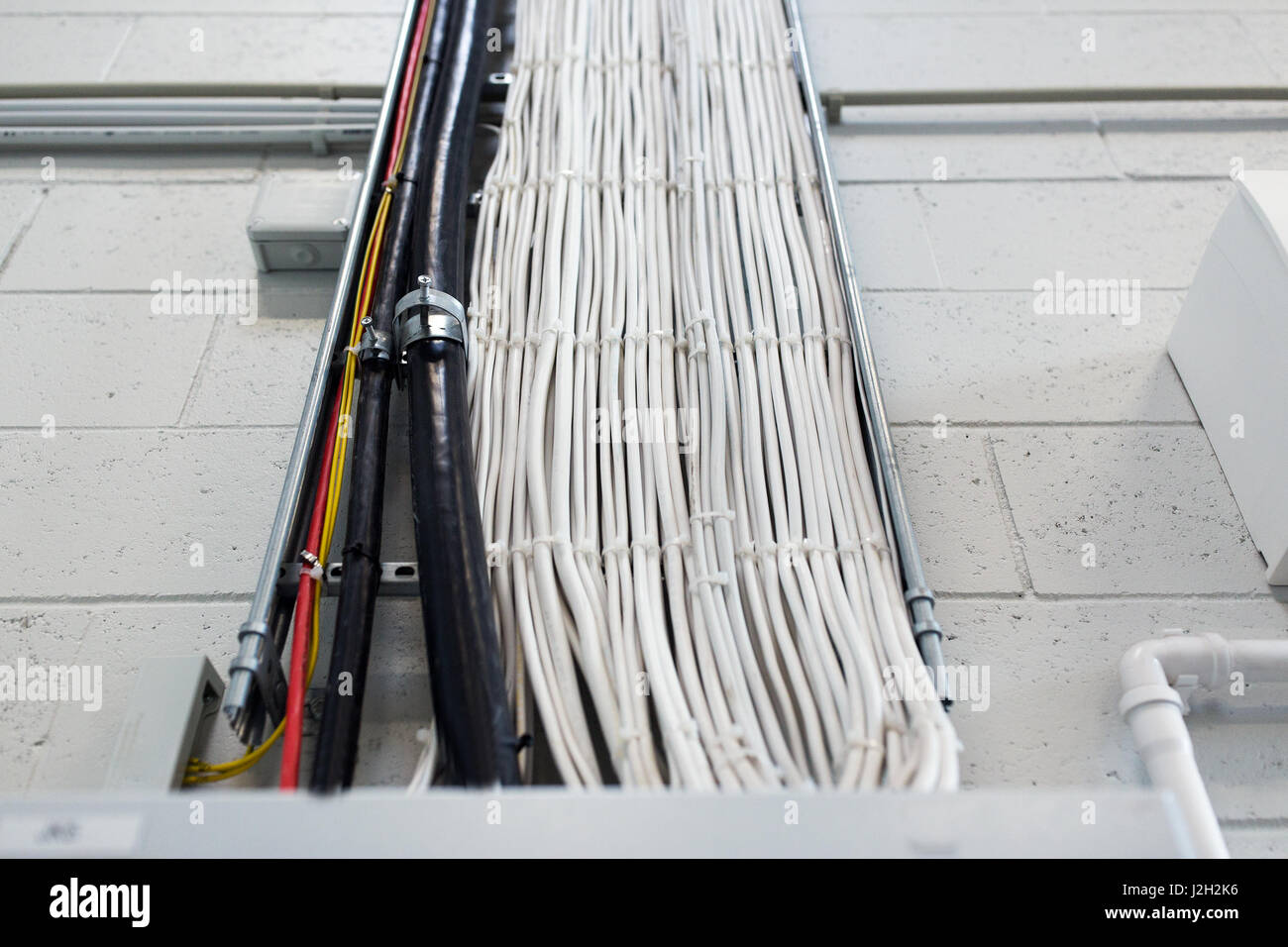group of electricity cables at wall Stock Photo - Alamy