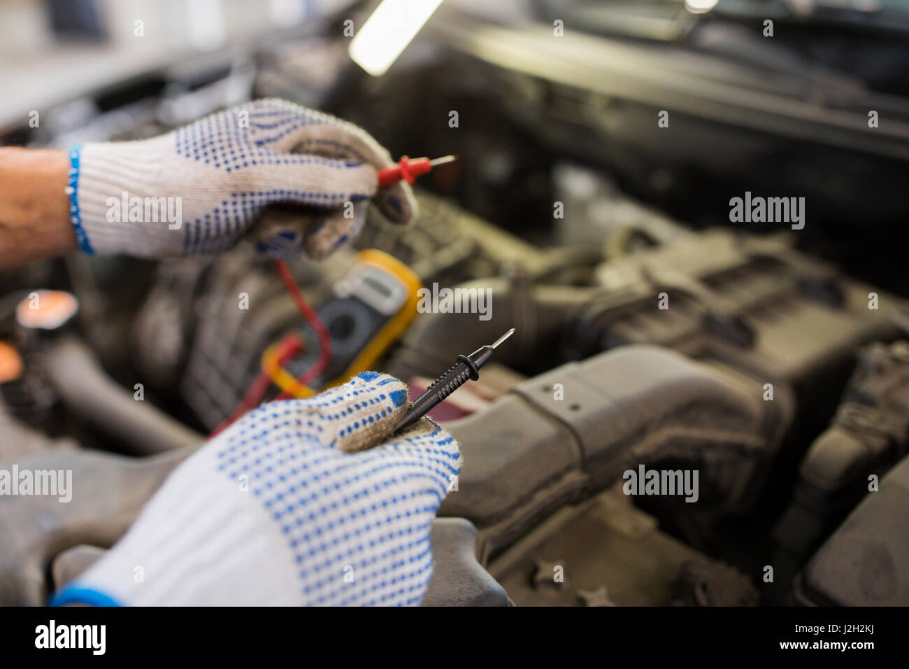 auto mechanic man with multimeter testing battery Stock Photo - Alamy