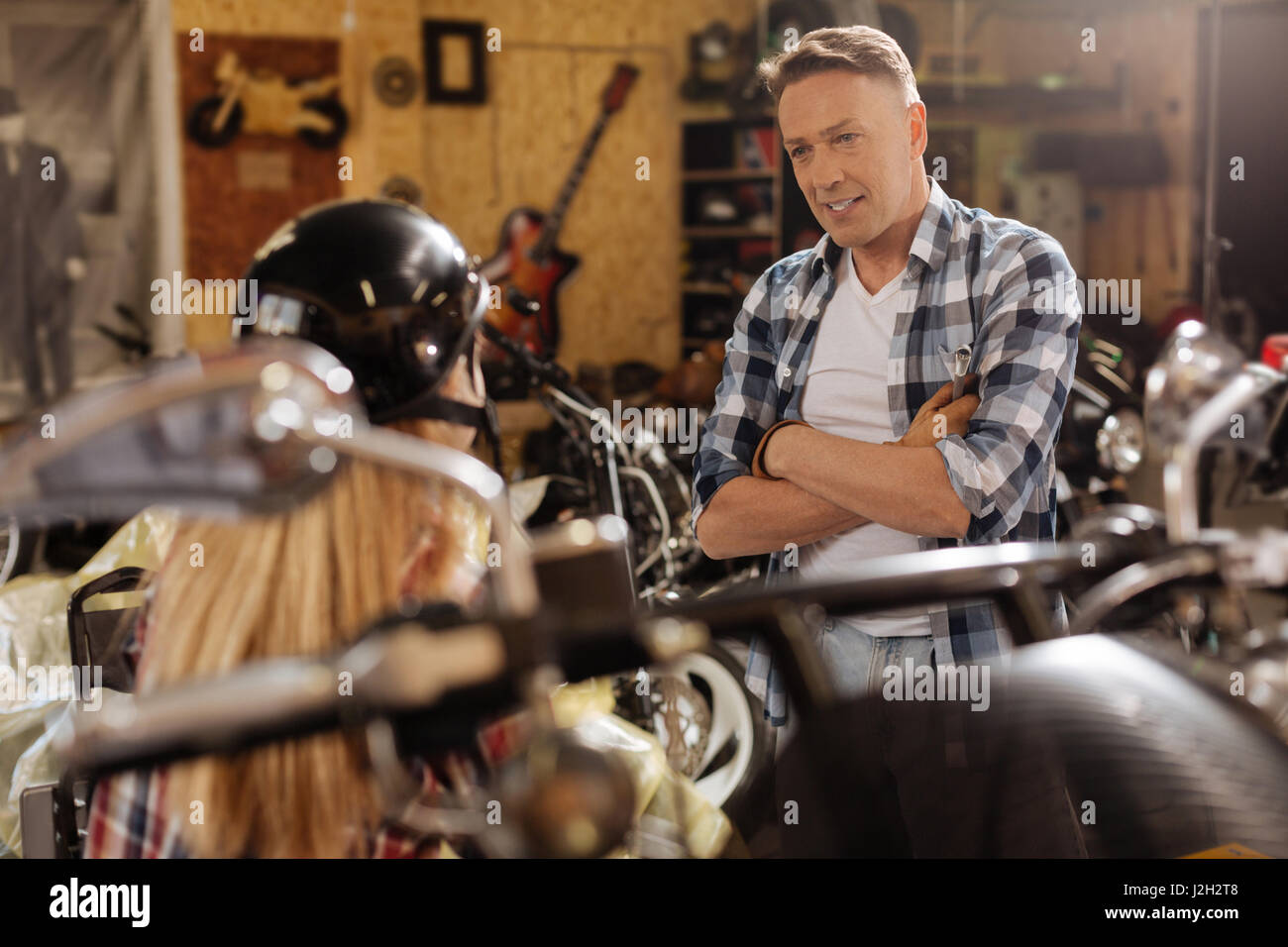 Wise successful mechanic conducting a little lecture Stock Photo - Alamy