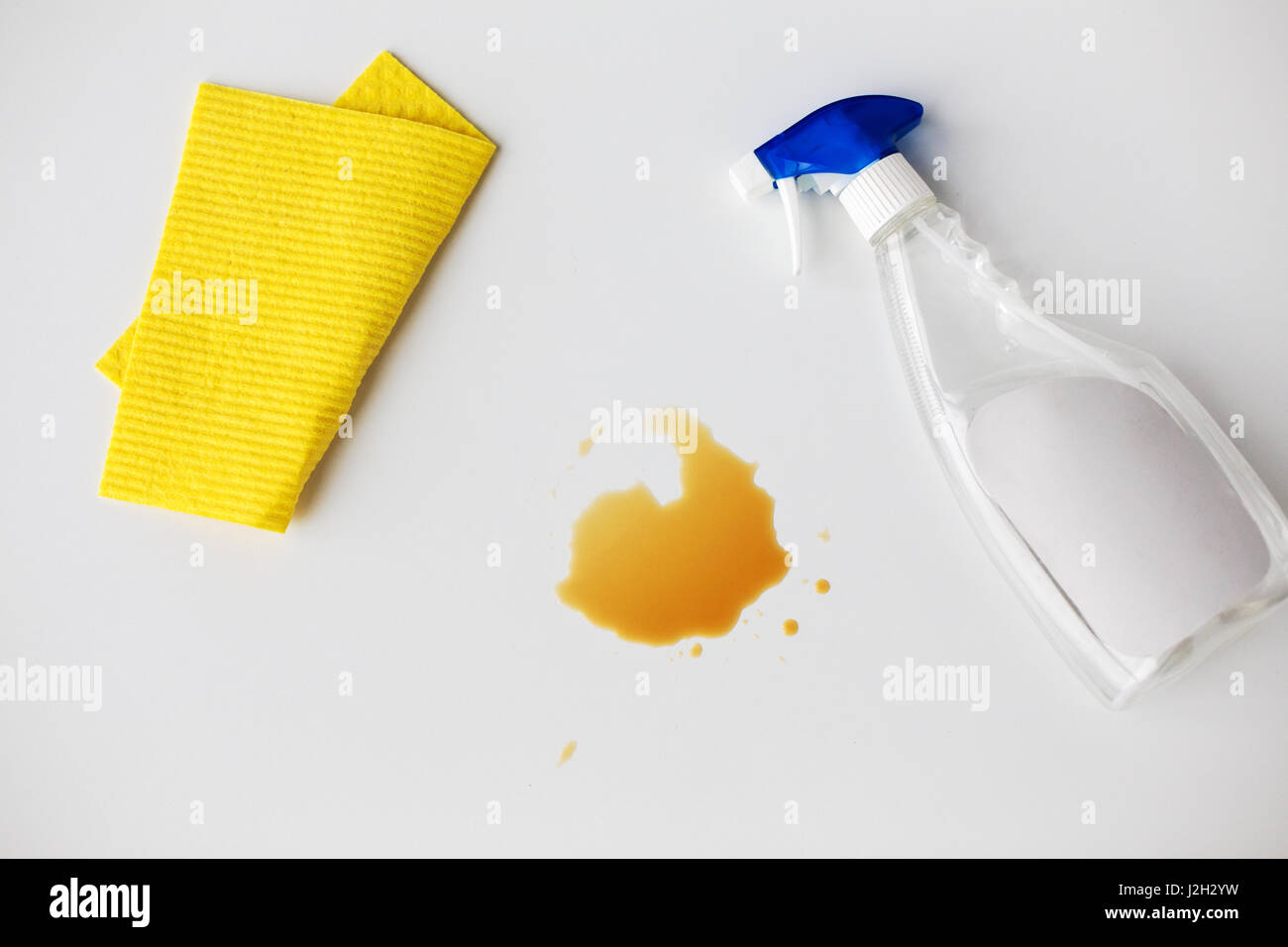 cleaning rag, detergent spray and spilled stain Stock Photo - Alamy
