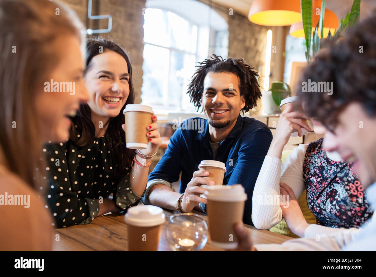 happy friends drinking coffee at restaurant Stock Photo - Alamy
