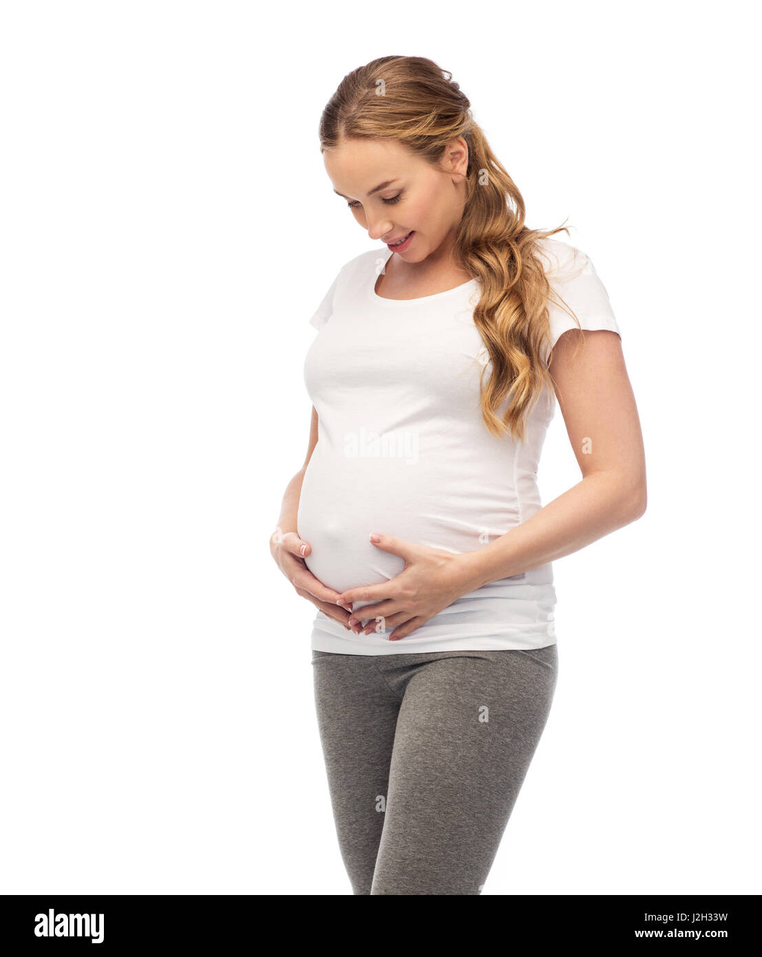 happy pregnant woman touching her big belly Stock Photo - Alamy