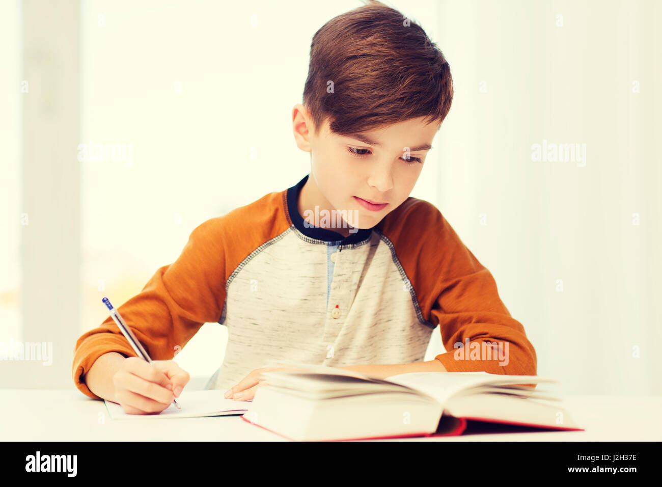 Boy writing book hi-res stock photography and images - Alamy