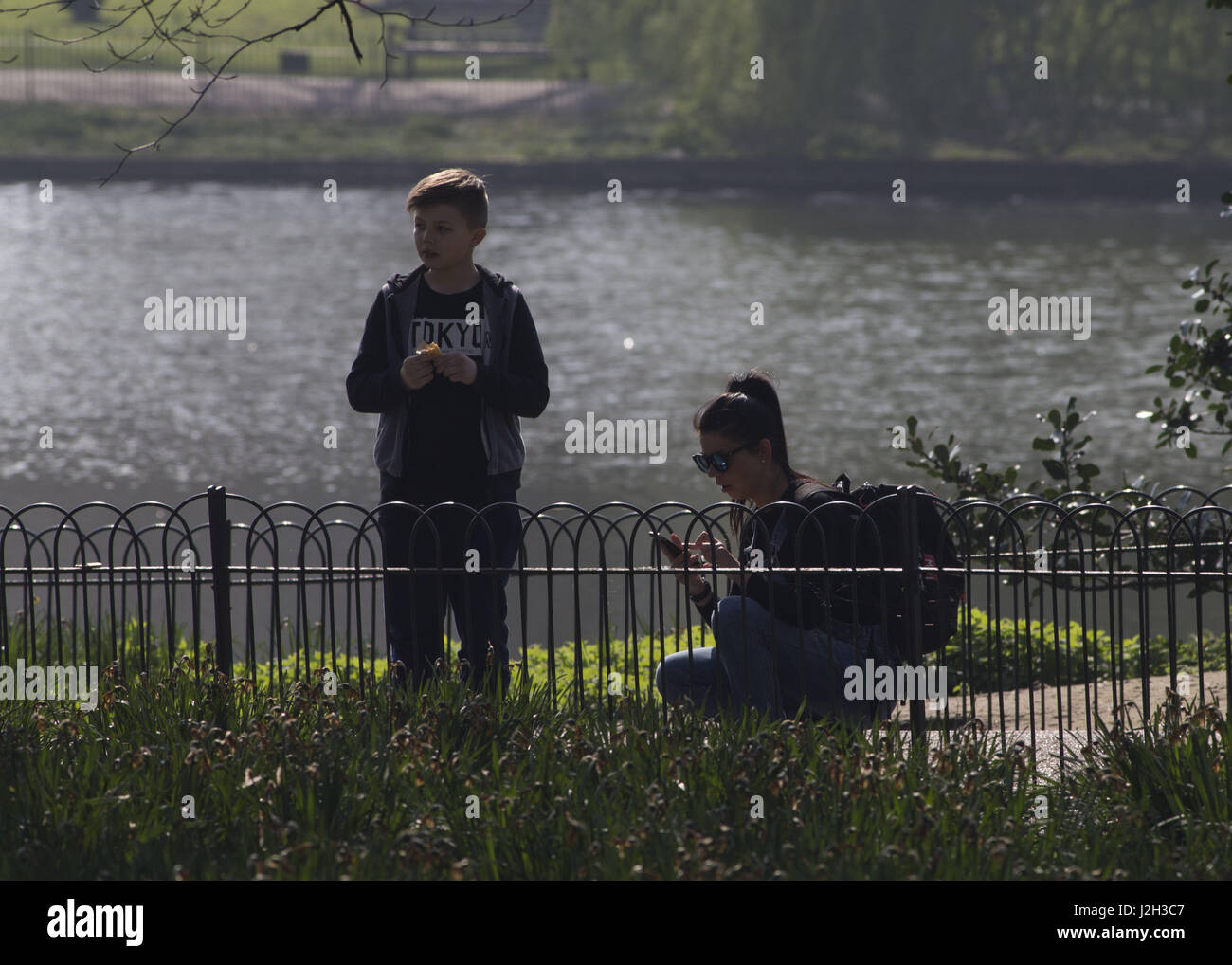 People enjoying the spring weather in St James Park, London. Featuring ...