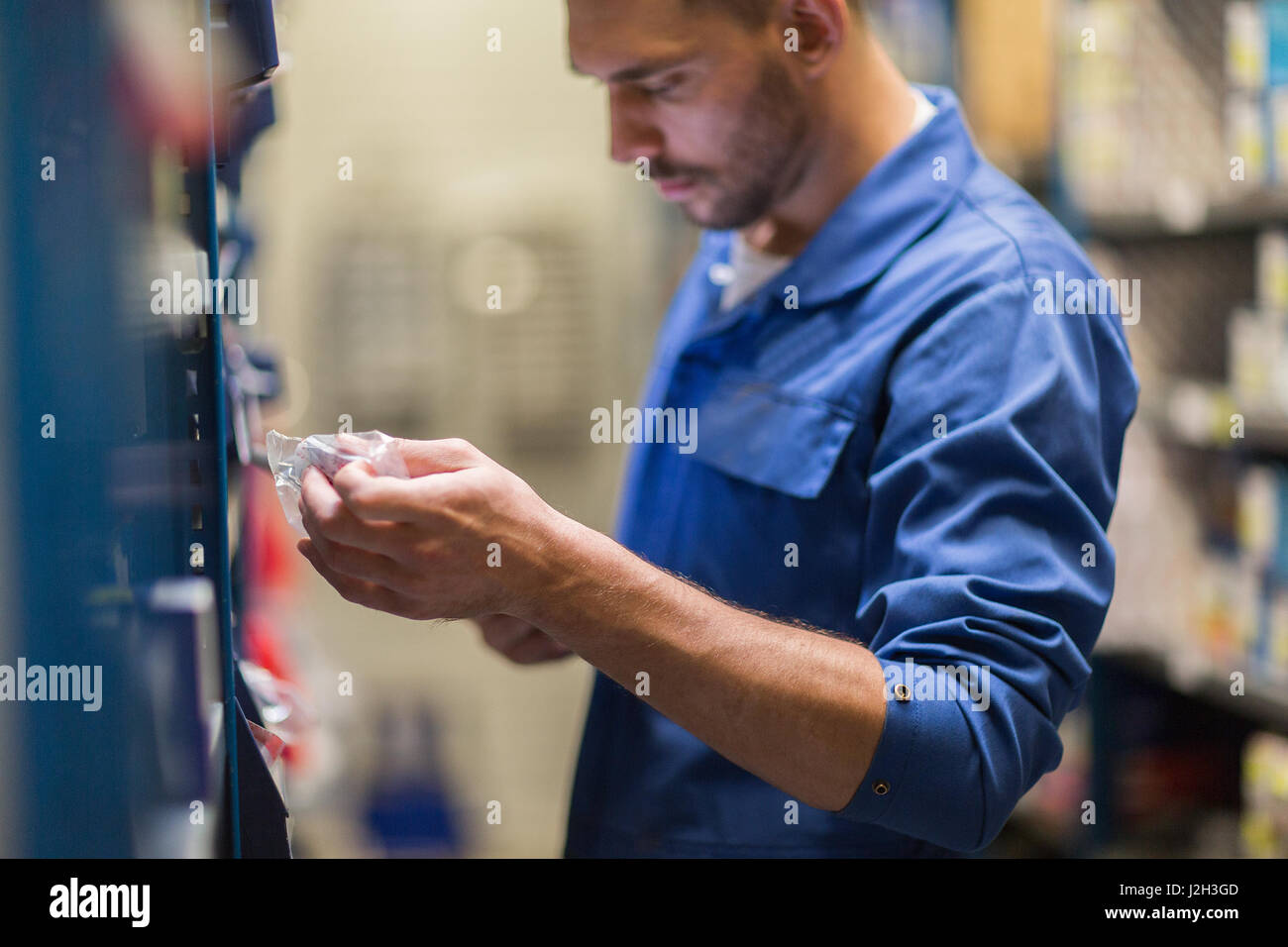 auto mechanic or smith at workshop or warehouse Stock Photo - Alamy