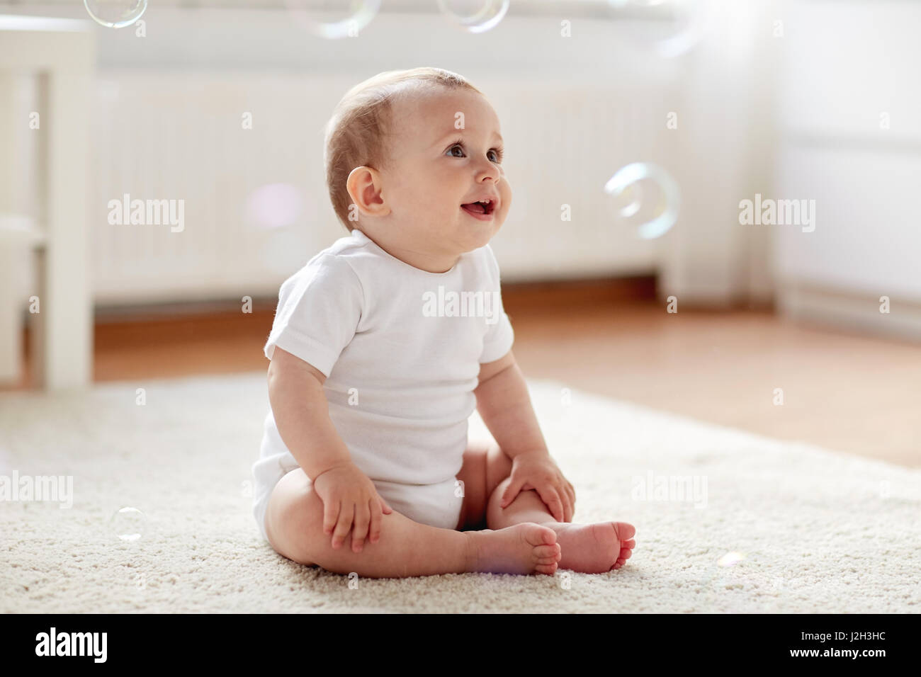 happy baby with soap bubbles at home Stock Photo - Alamy