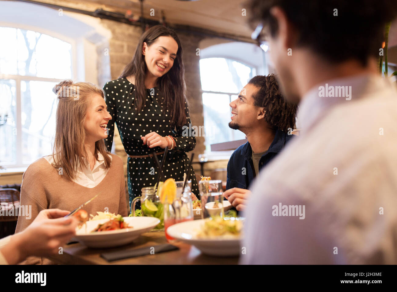 happy friends eating and drinking at restaurant Stock Photo - Alamy