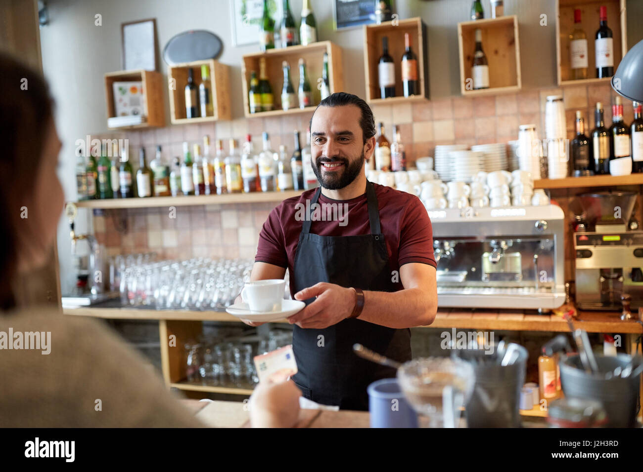man or waiter serving customer at coffee shop Stock Photo - Alamy