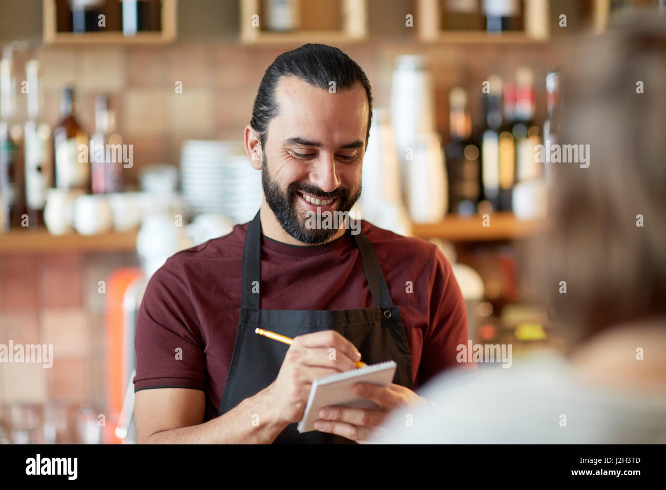 man or waiter serving customer at bar Stock Photo - Alamy