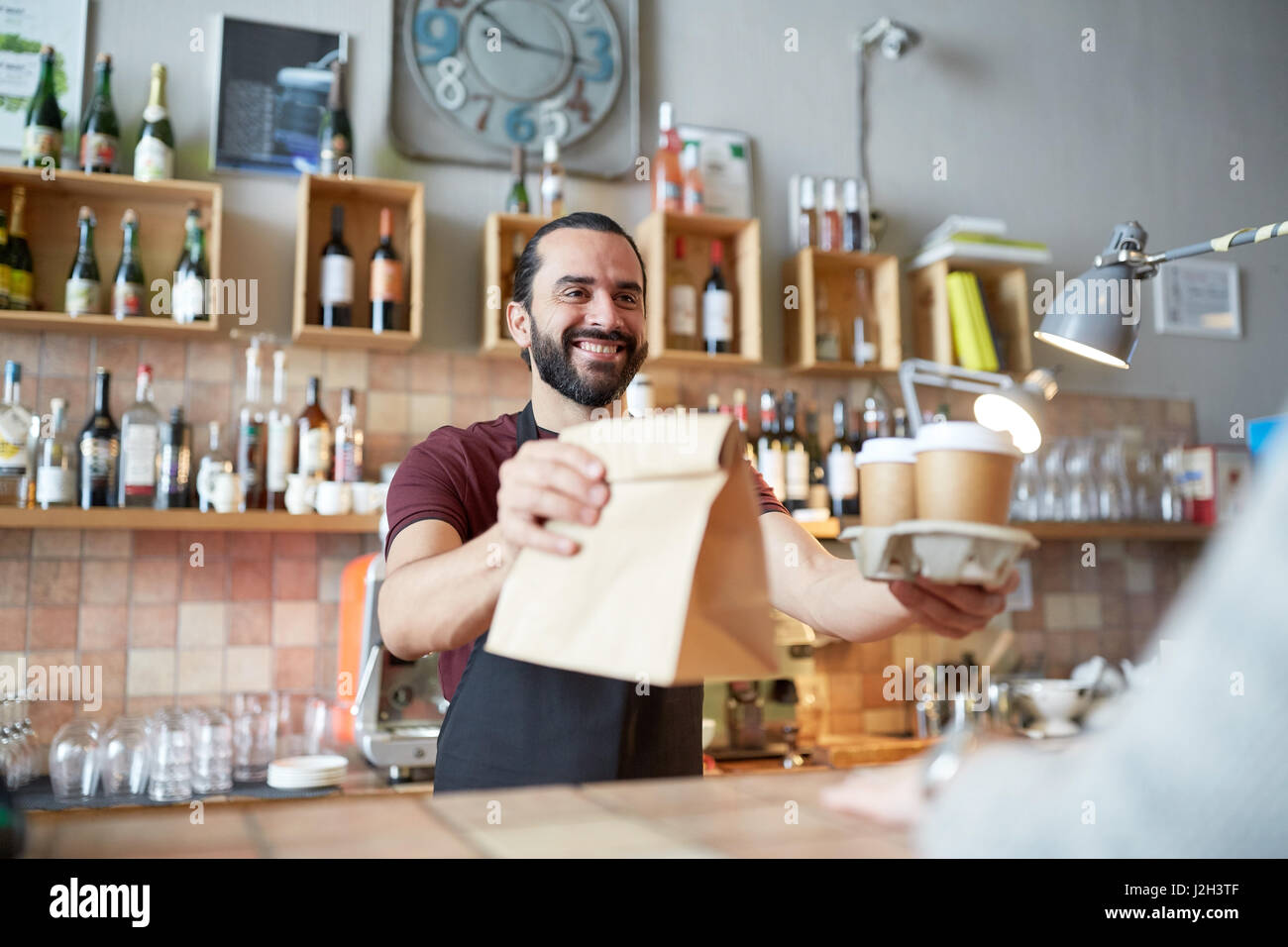 man or waiter serving customer at coffee shop Stock Photo - Alamy
