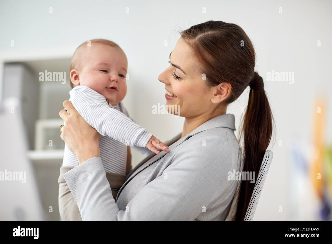 happy businesswoman with baby at office Stock Photo - Alamy