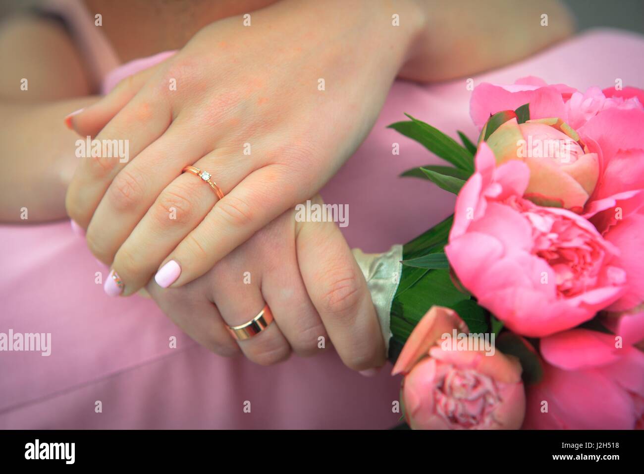 Woman with a bouquet of flowers hugging her husband Stock Photo - Alamy