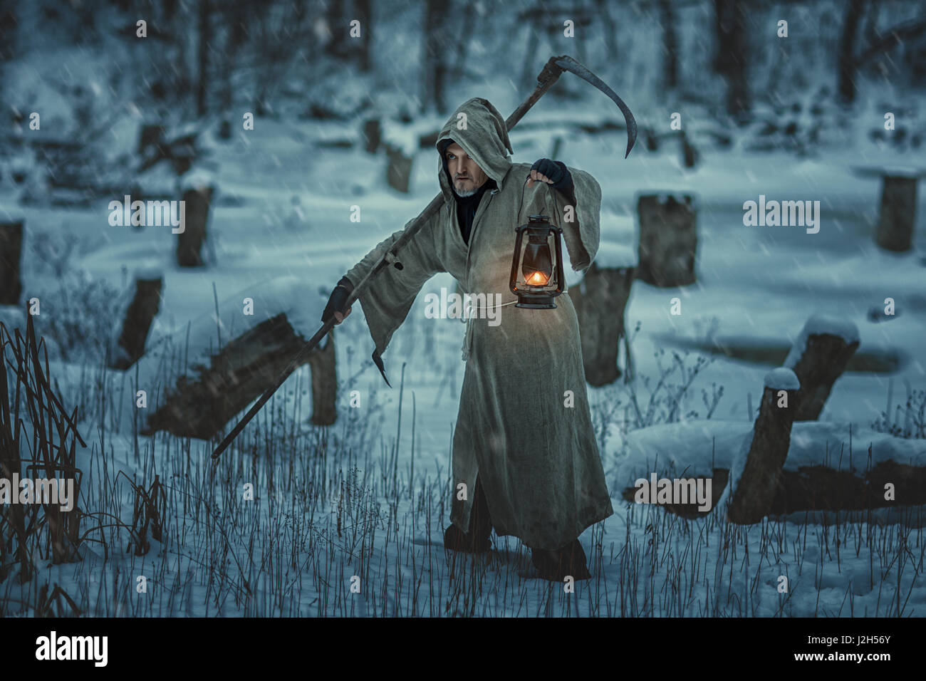 Grim reaper with a scythe is on the field. In winter, the snow comes ...