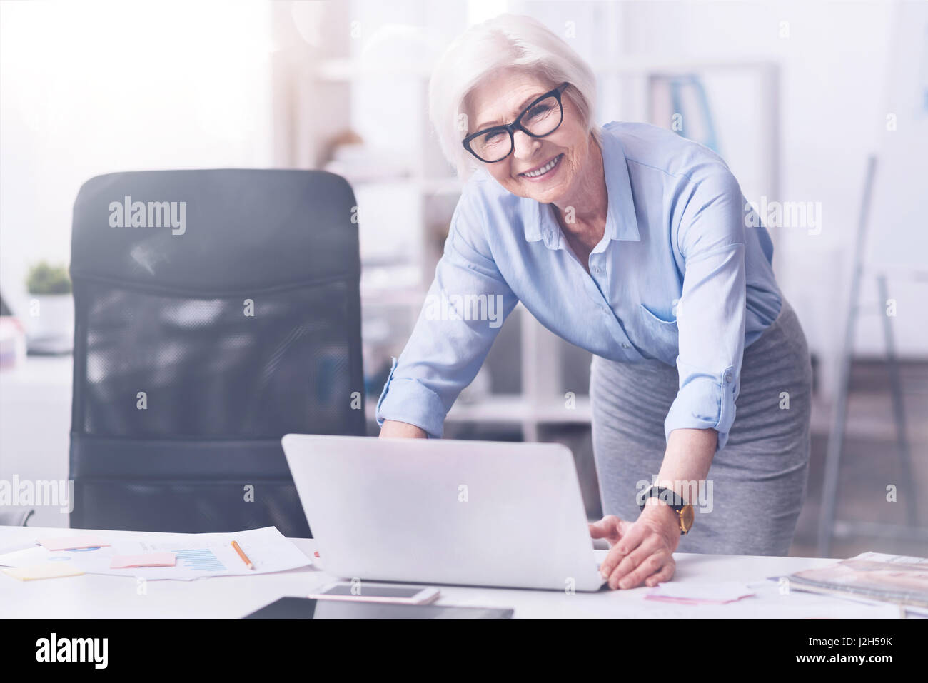Magnificent retirement worker smiling on camera Stock Photo - Alamy
