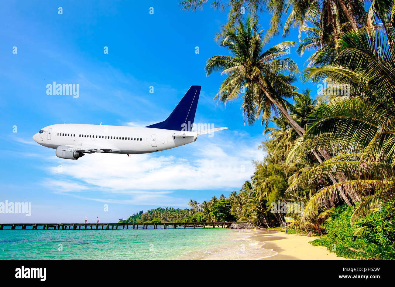 Plane fly over ocean Stock Photo - Alamy