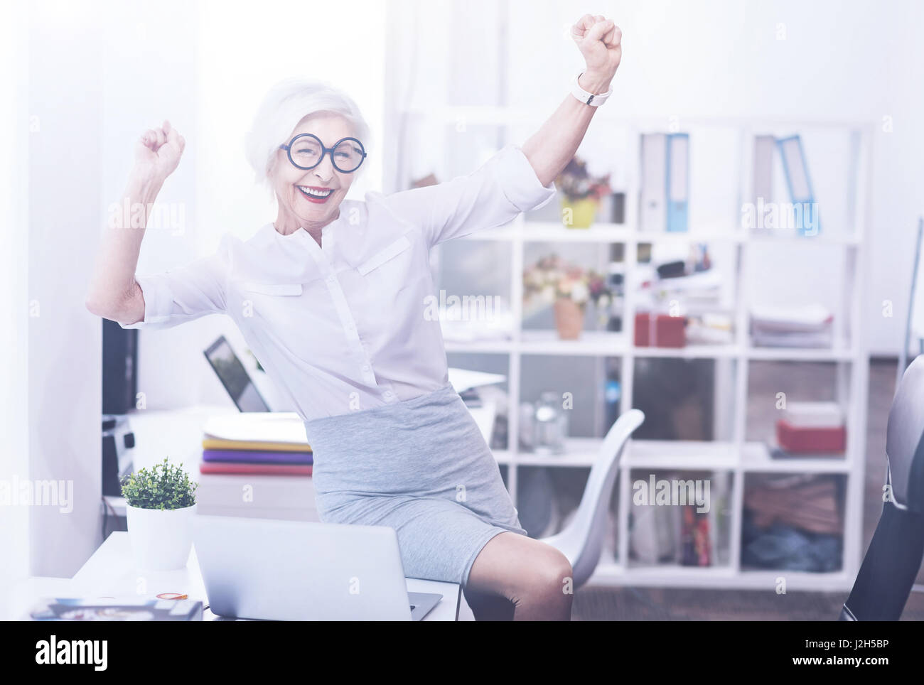 Happy female office worker being very glad Stock Photo - Alamy
