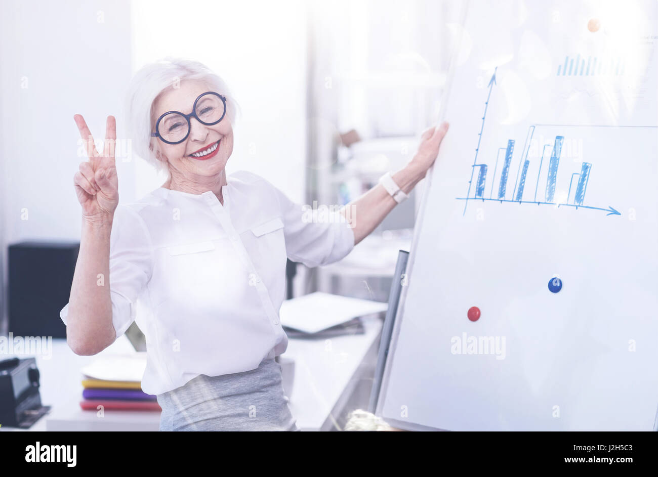 Modern retirement female standing near scheme Stock Photo - Alamy