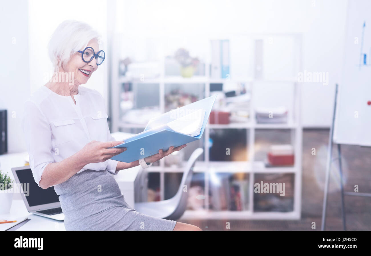 Funny blonde woman posing with big folder in hands Stock Photo - Alamy