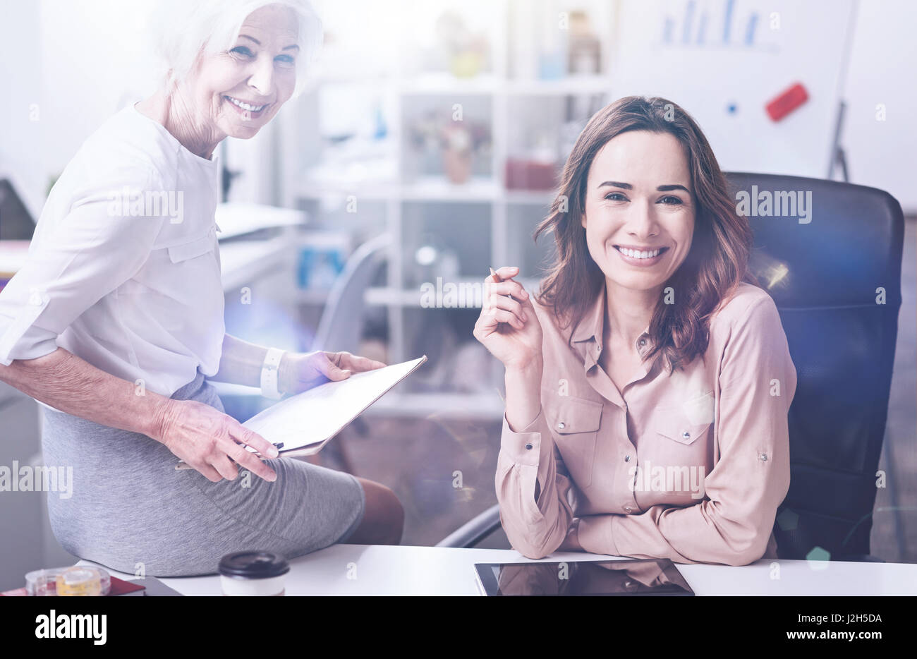 Amazing colleagues smiling on camera Stock Photo - Alamy