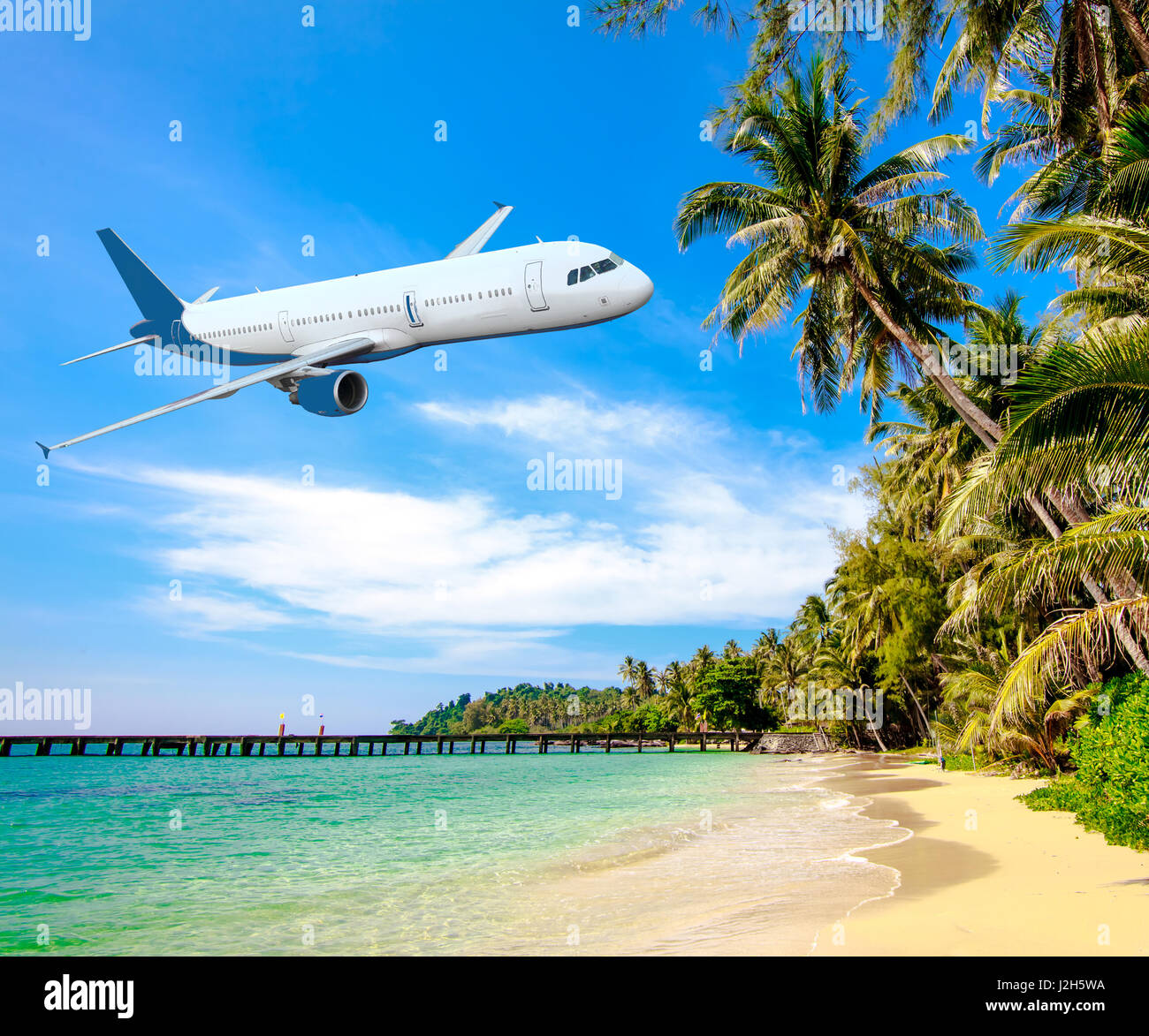 Jet plane over the tropical sea Stock Photo - Alamy