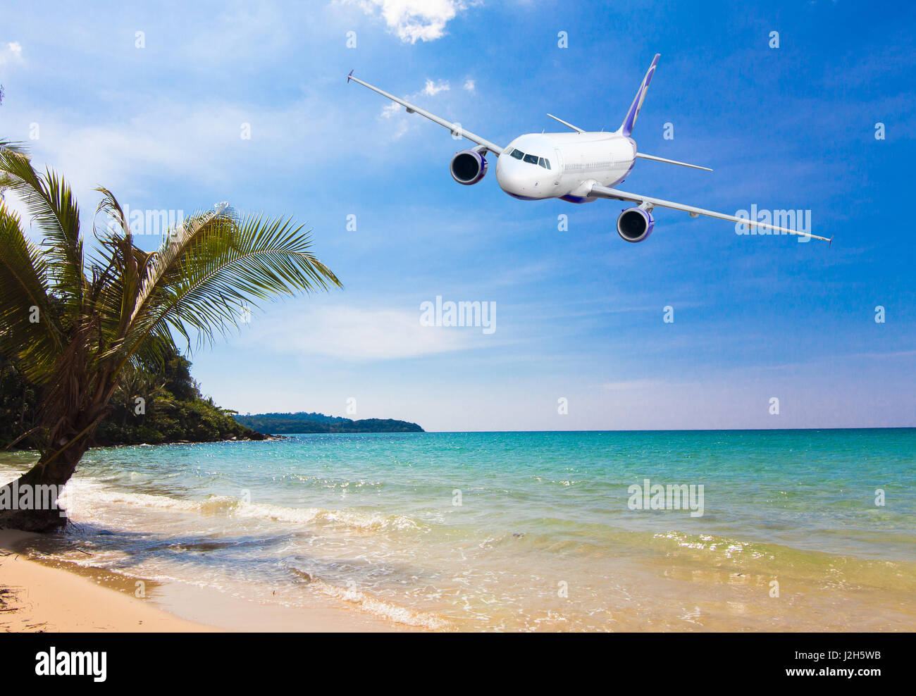 Plane fly over ocean Stock Photo - Alamy