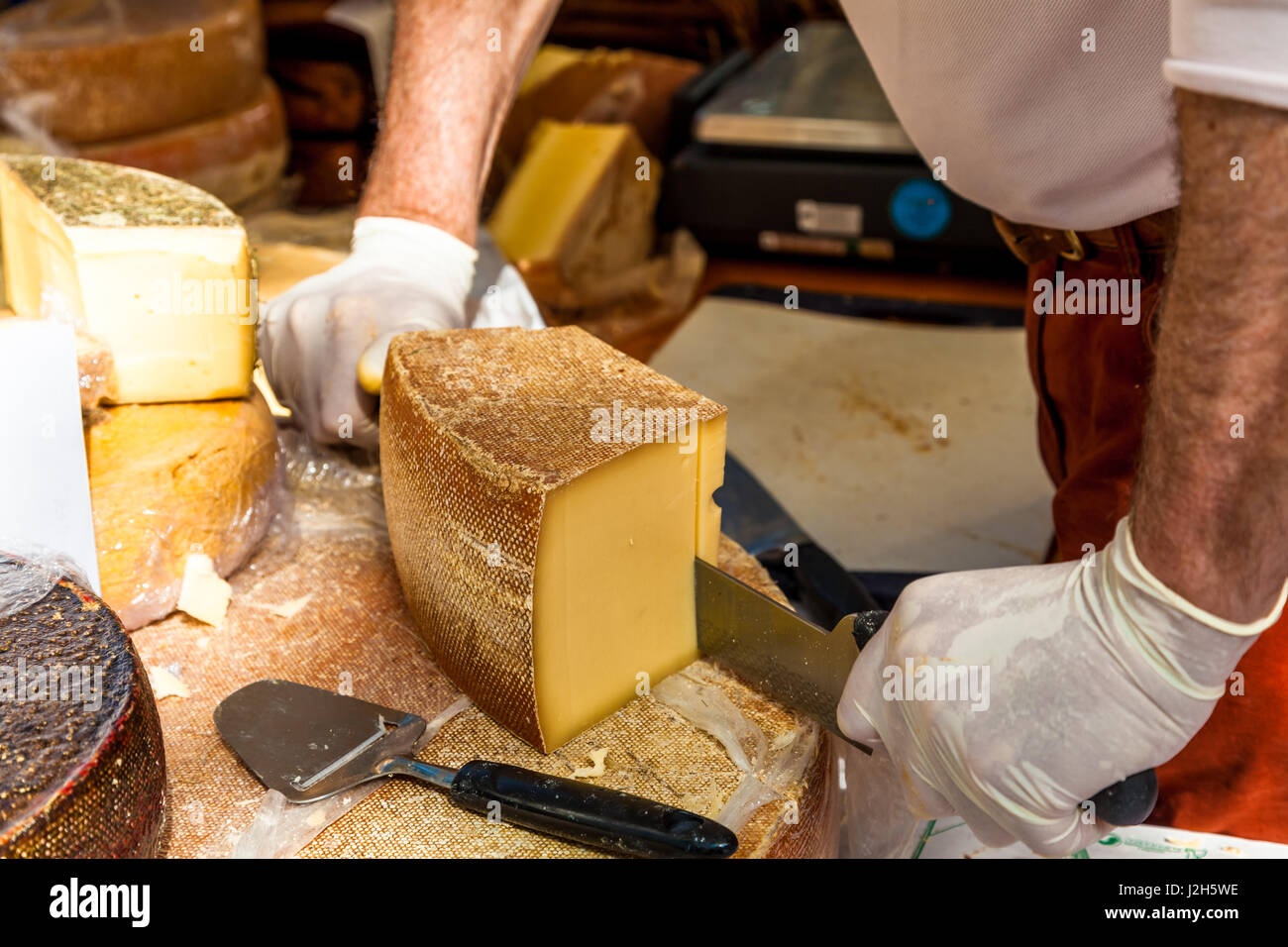 Man cutting piece of cheese Stock Photo - Alamy