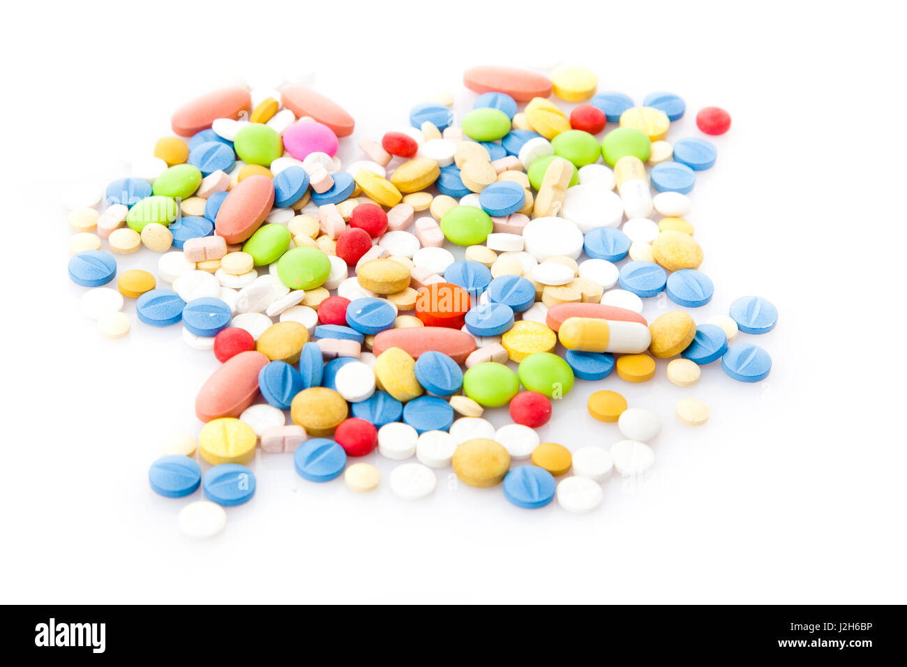 Pile of various colorful pills isolated on white Stock Photo - Alamy