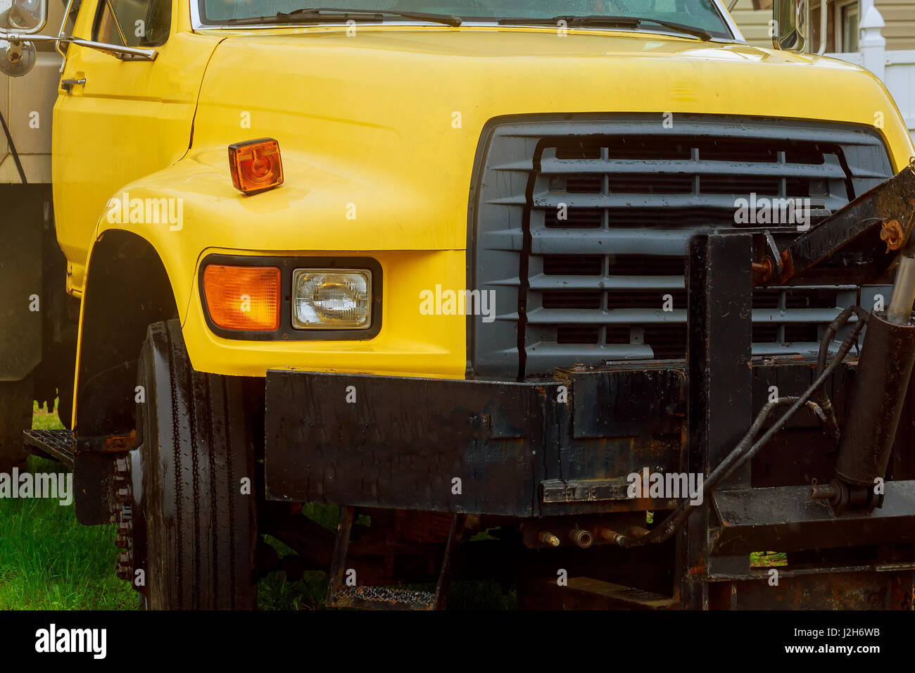 Close up front view of yellow truck, vehicle, yard, yellowpick-uptruck ...