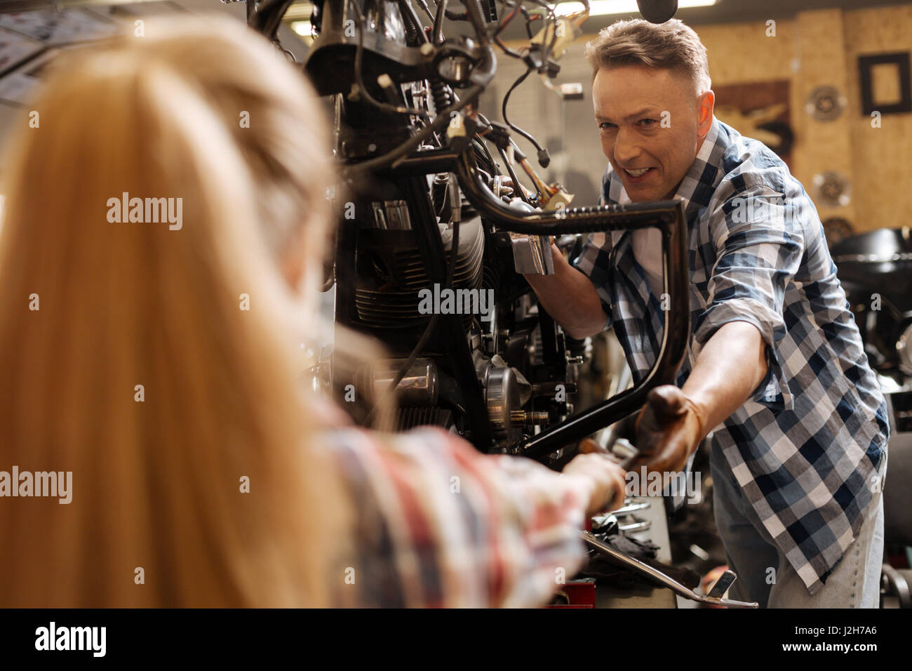 Happy hardworking dad receiving some help Stock Photo - Alamy