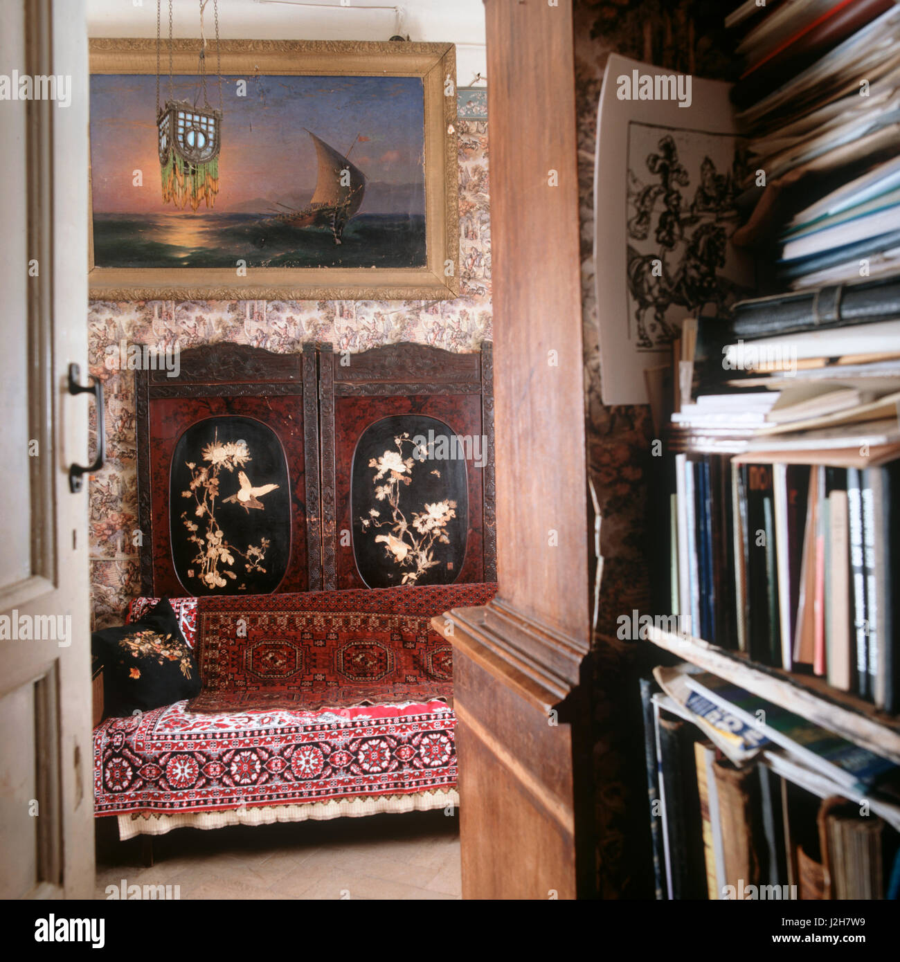 Screen behind patterned sofa Stock Photo - Alamy