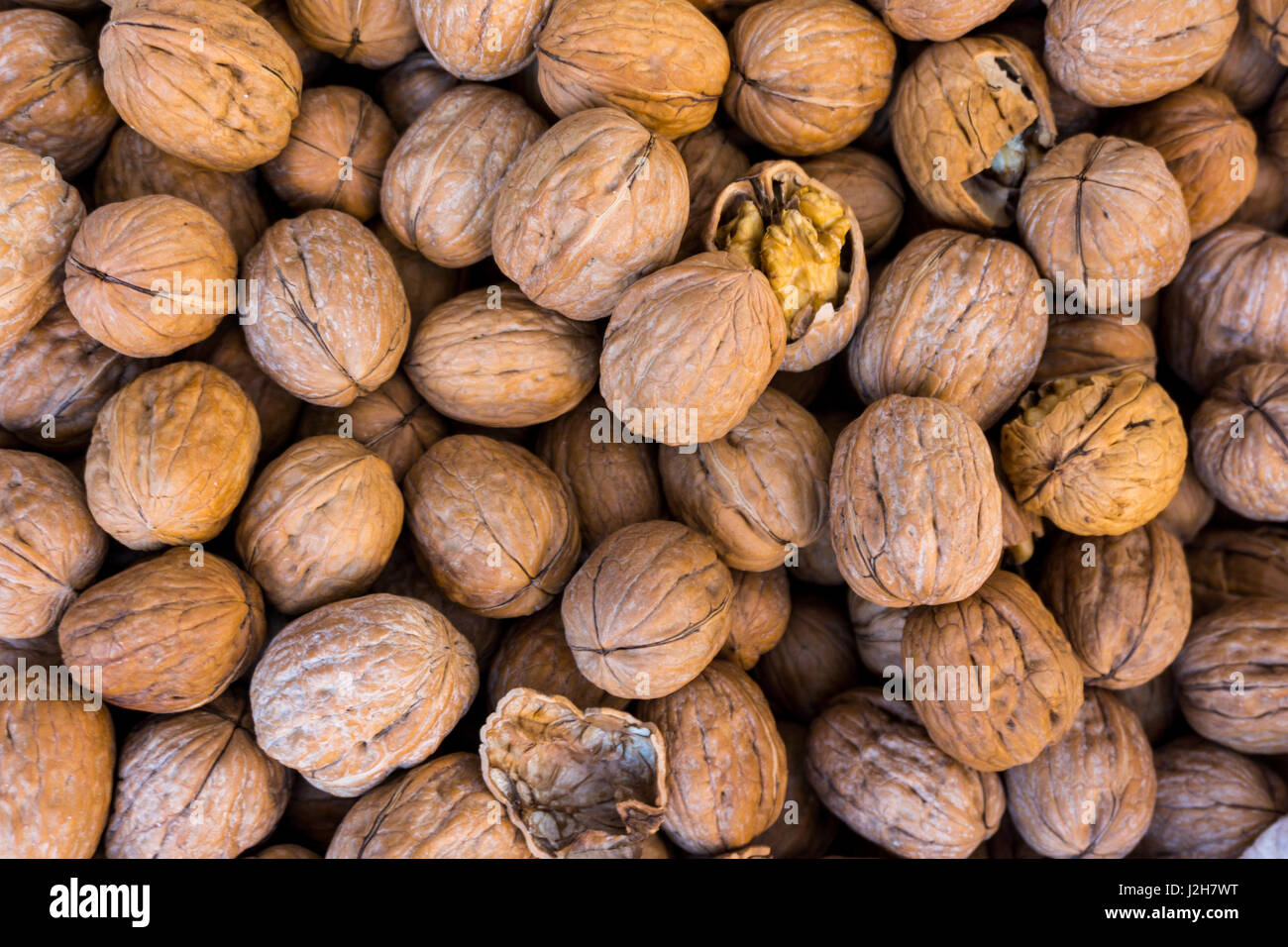 Walnut background. lot of walnuts in the peel Stock Photo - Alamy