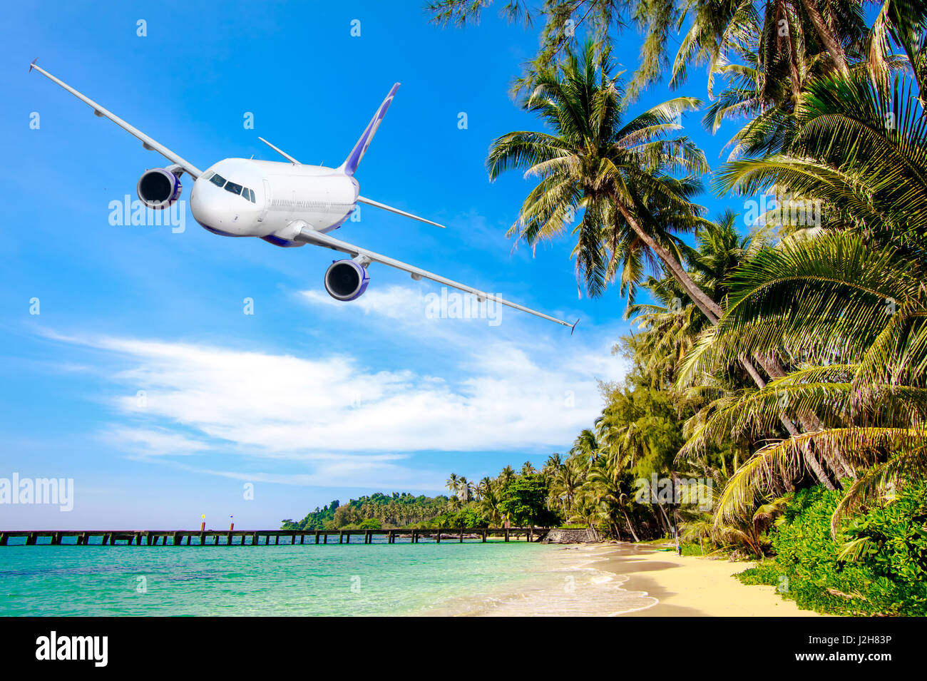 Plane fly over ocean Stock Photo - Alamy