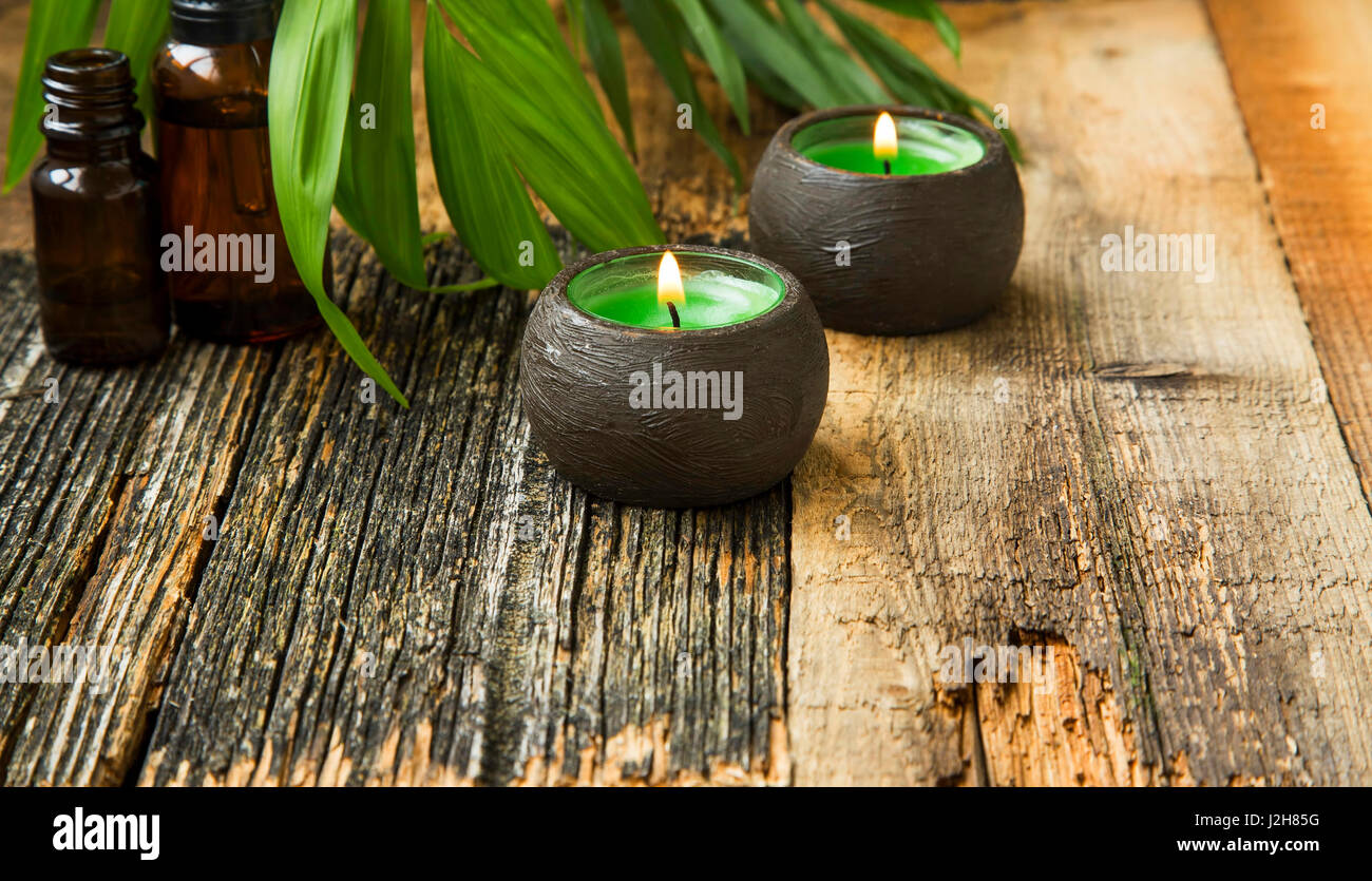 Spa candle setting with green leaves on wooden background Stock Photo ...