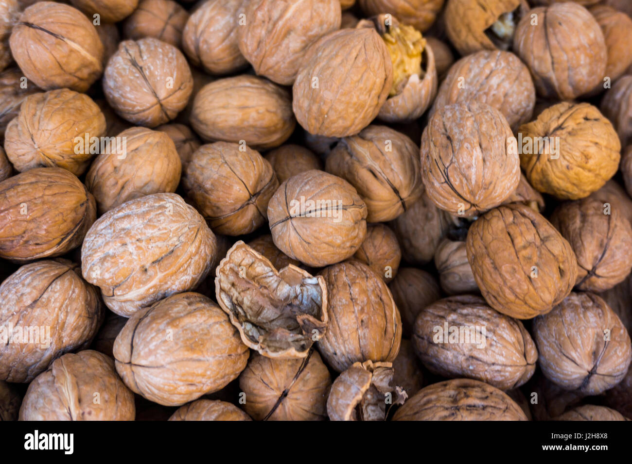 Walnut background. lot of walnuts in the peel Stock Photo - Alamy