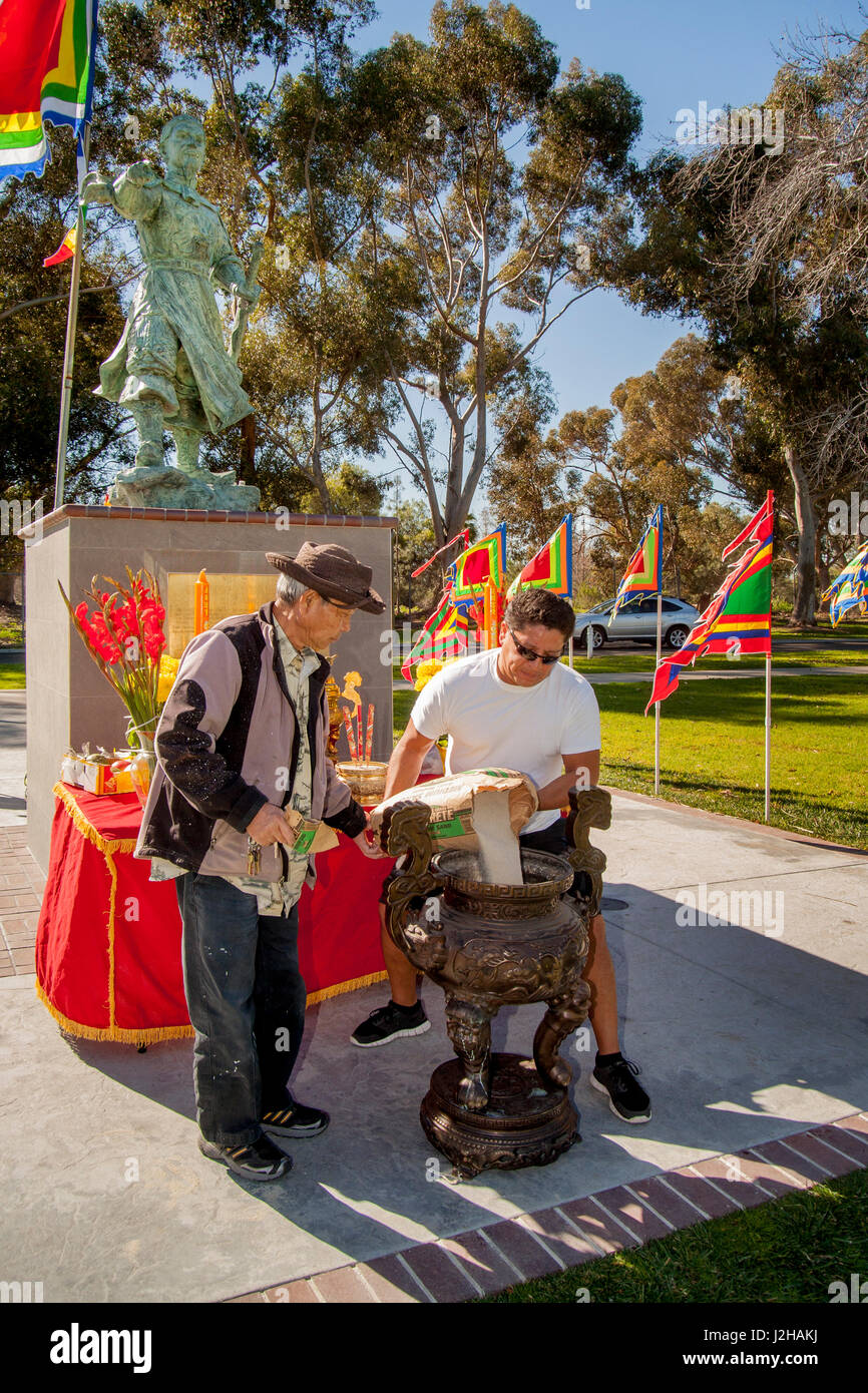A local Vietnamese American gets some help from a Hispanic neighbor in ...