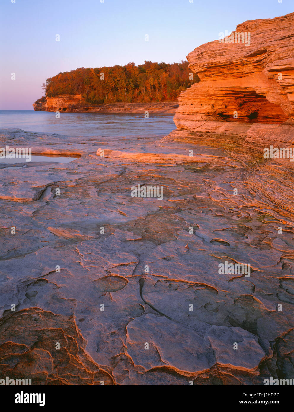 USA, Michigan, Pictured Rocks National Lakeshore, Sunset on eroded ...
