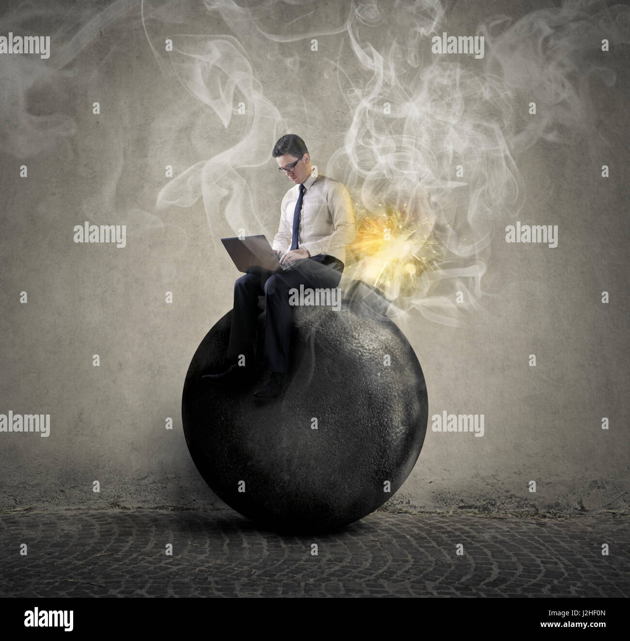 Businessman sitting on bomb Stock Photo - Alamy