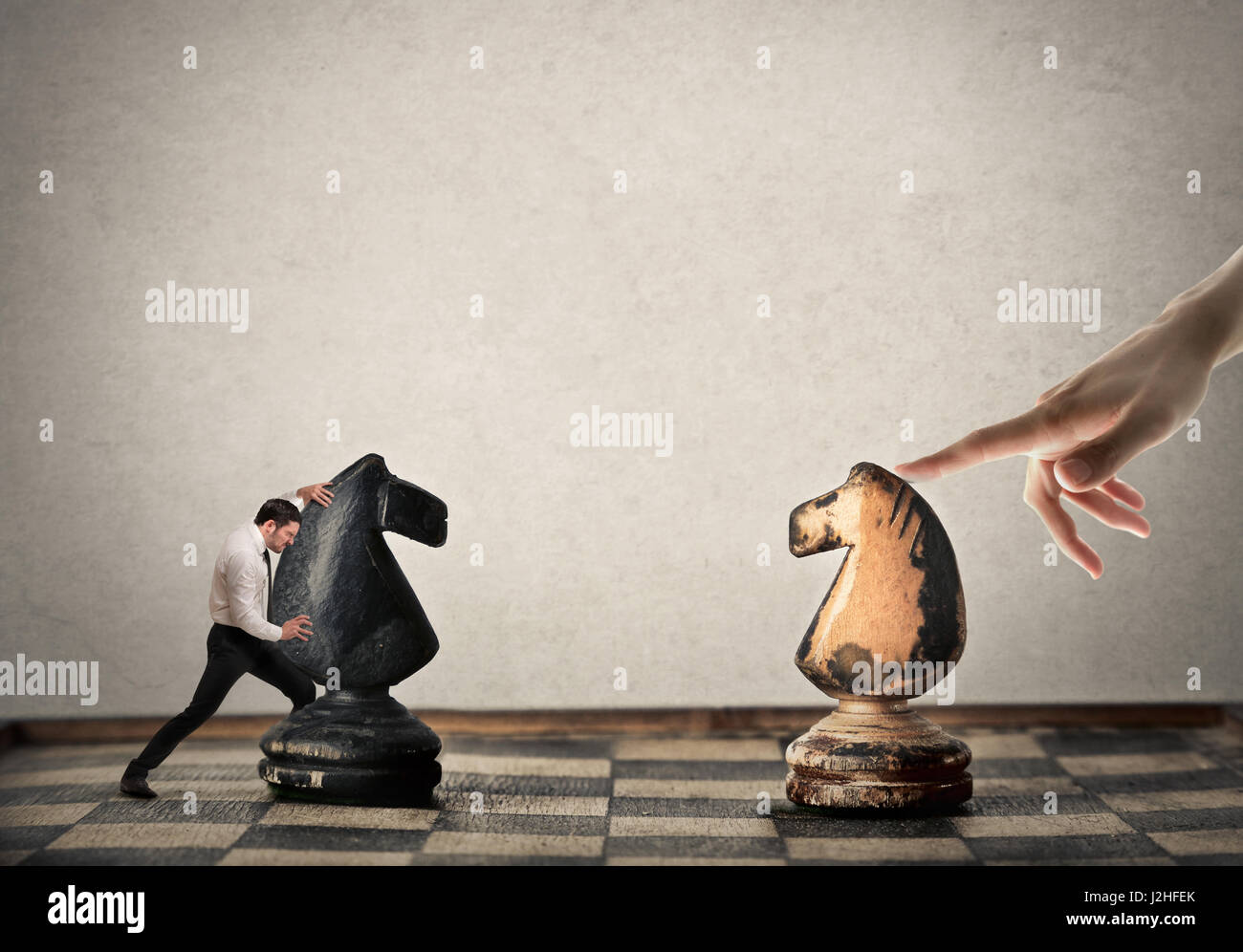 Businessman pushing chess figure while big hand pushes other Stock ... Businessman pushing chess figure while big hand pushes other Stock ...