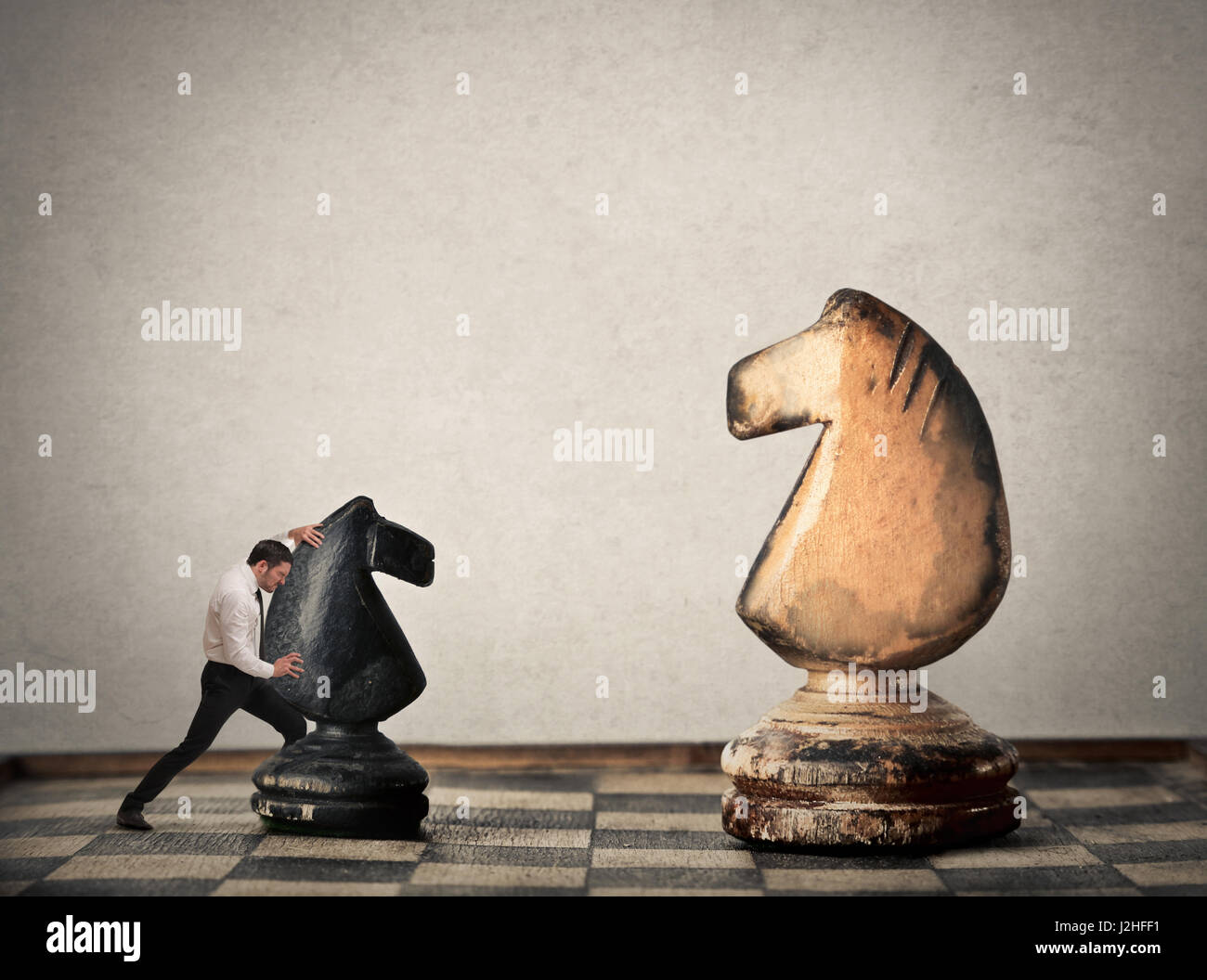 Businessman pushing chess figure Stock Photo - Alamy