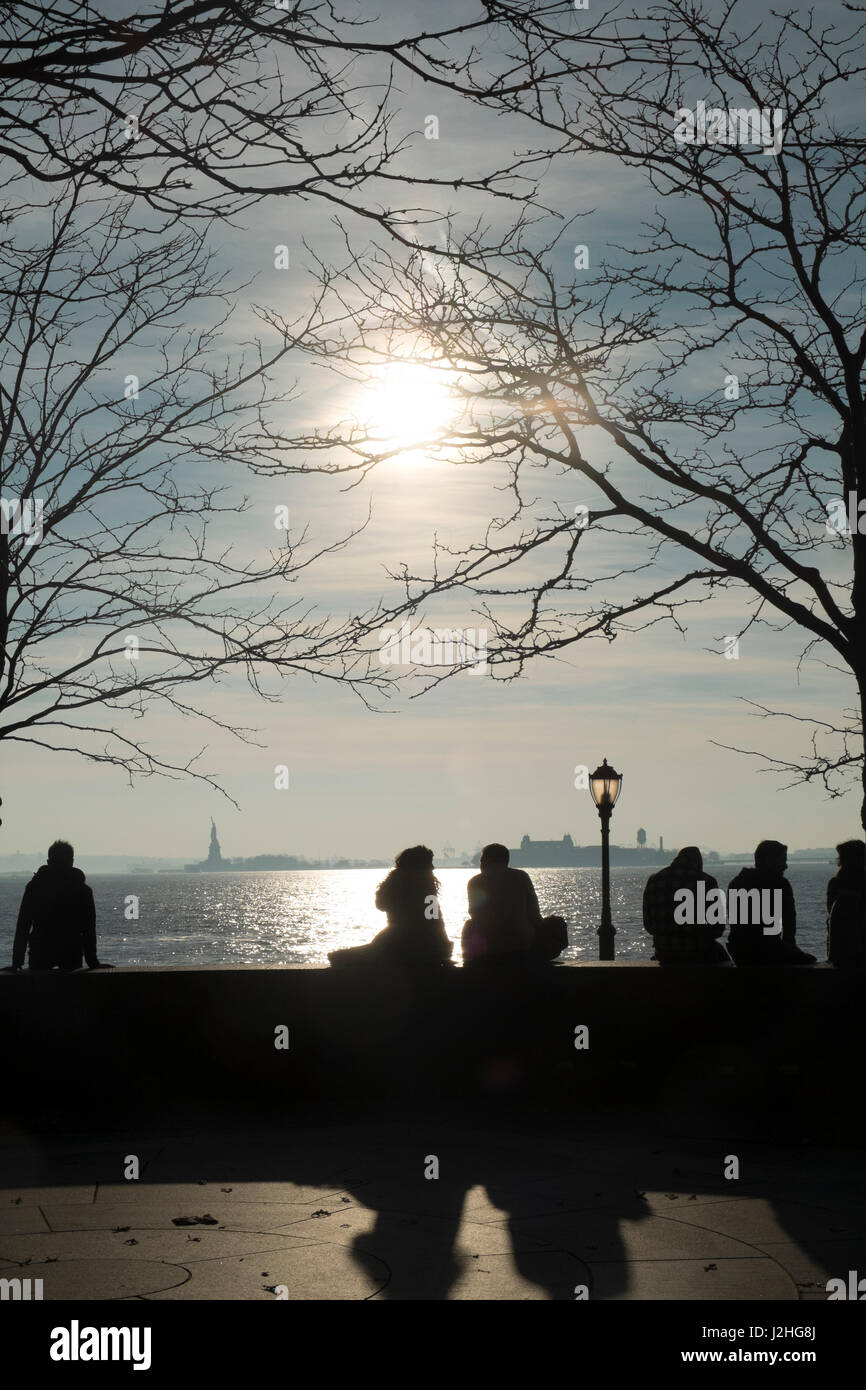 Couples enjoy a beautiful view over the bay at a waterfront park, New ...