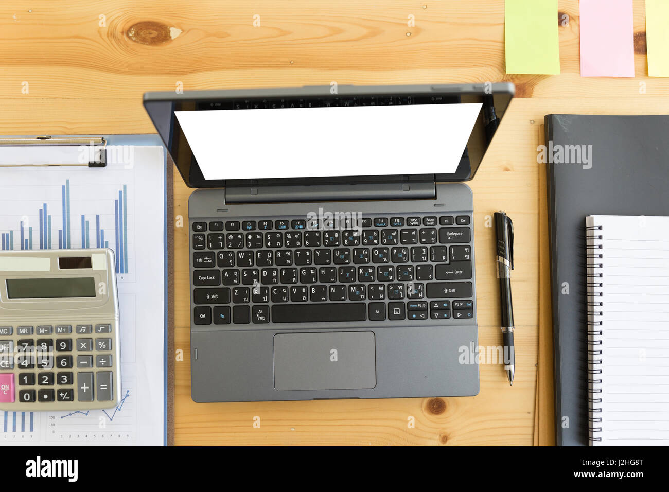 wood office table with notepad, computer, document and calculator. top ...
