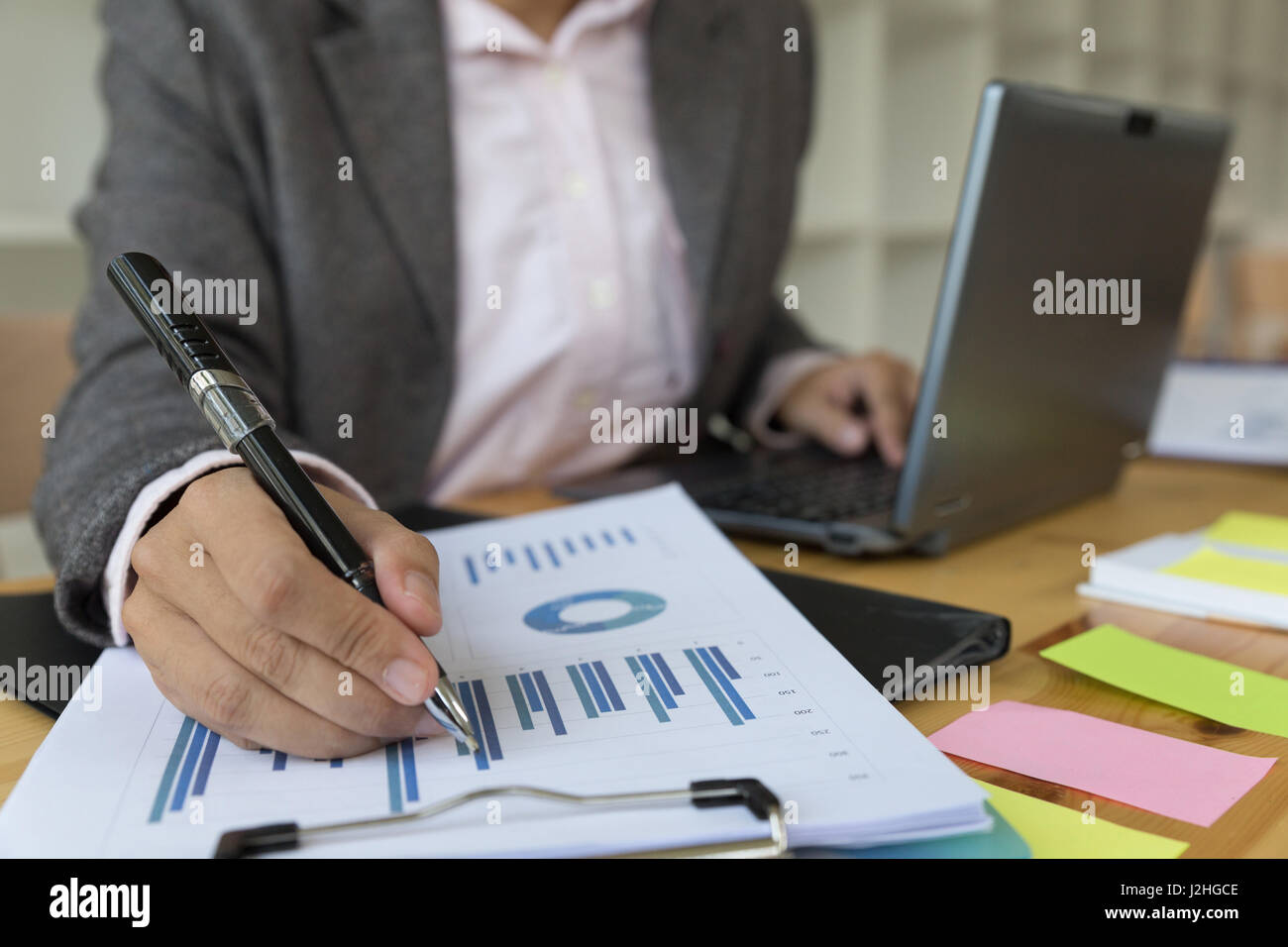 Business woman analyzing income charts and graphs with modern laptop ...